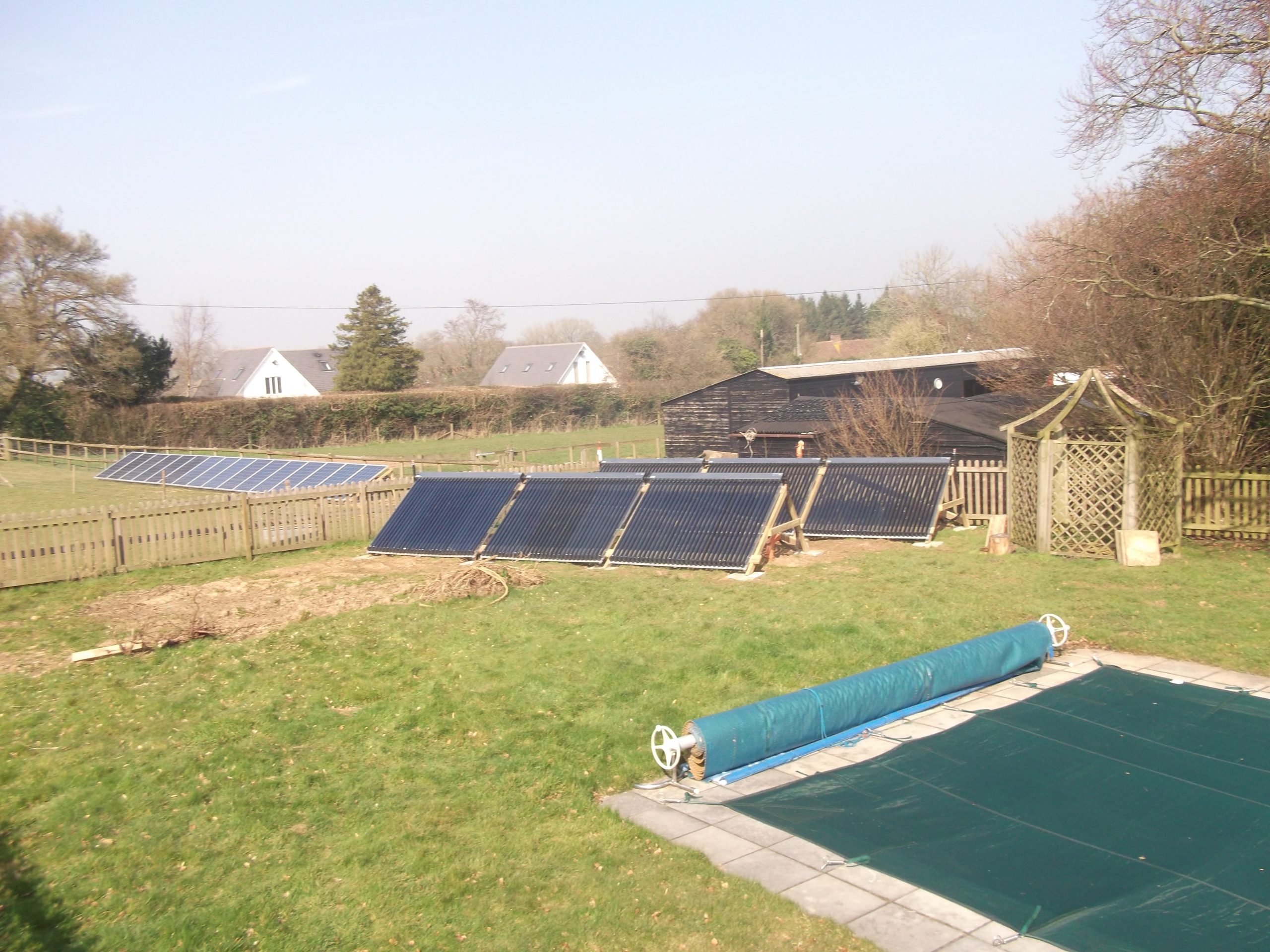 Ground-mounted solar thermal array heating a swimming pool and a 4.0 ...